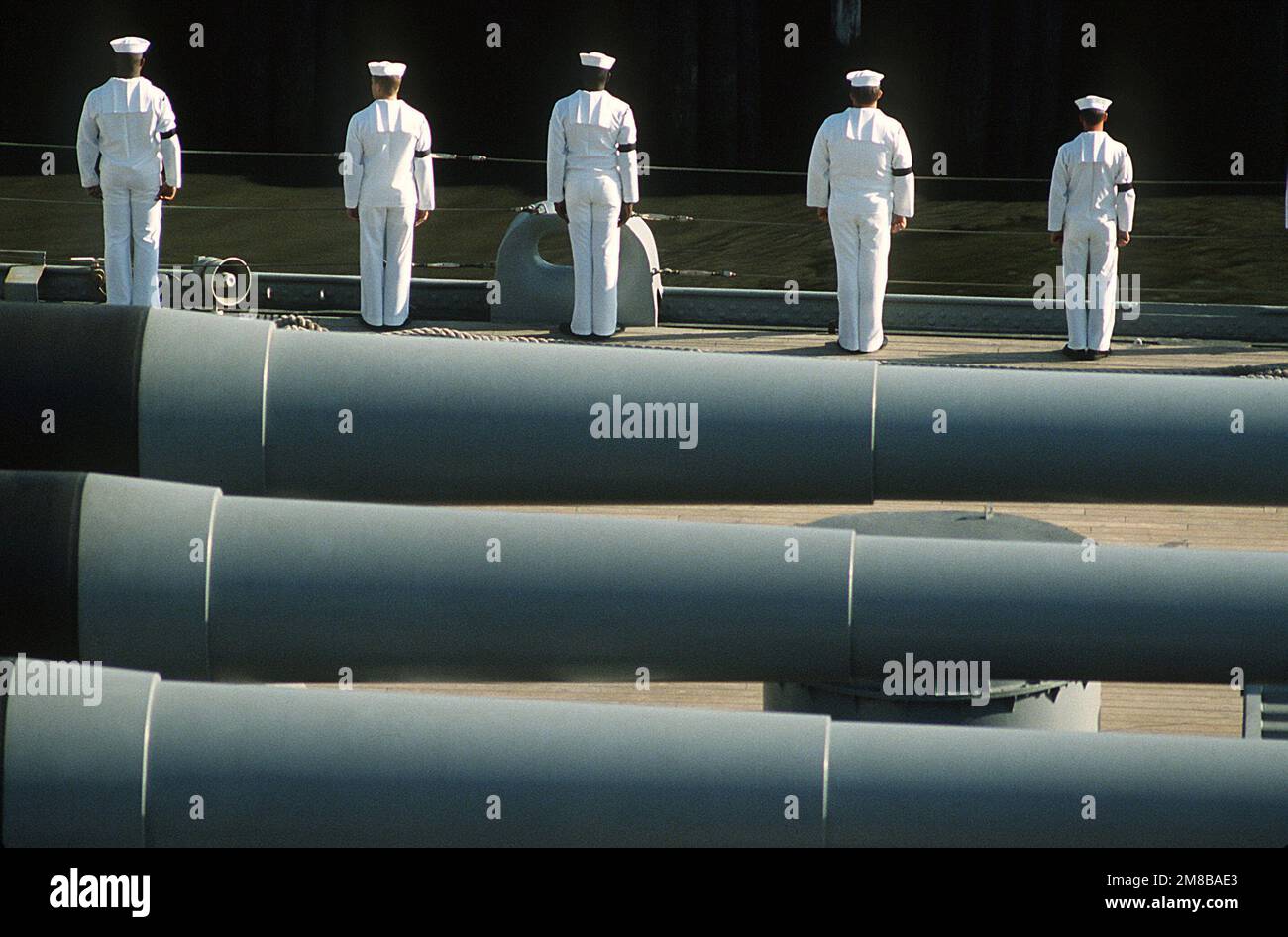 Beyond the barrels of the battleship's 16-inch guns, black arm-banded ...