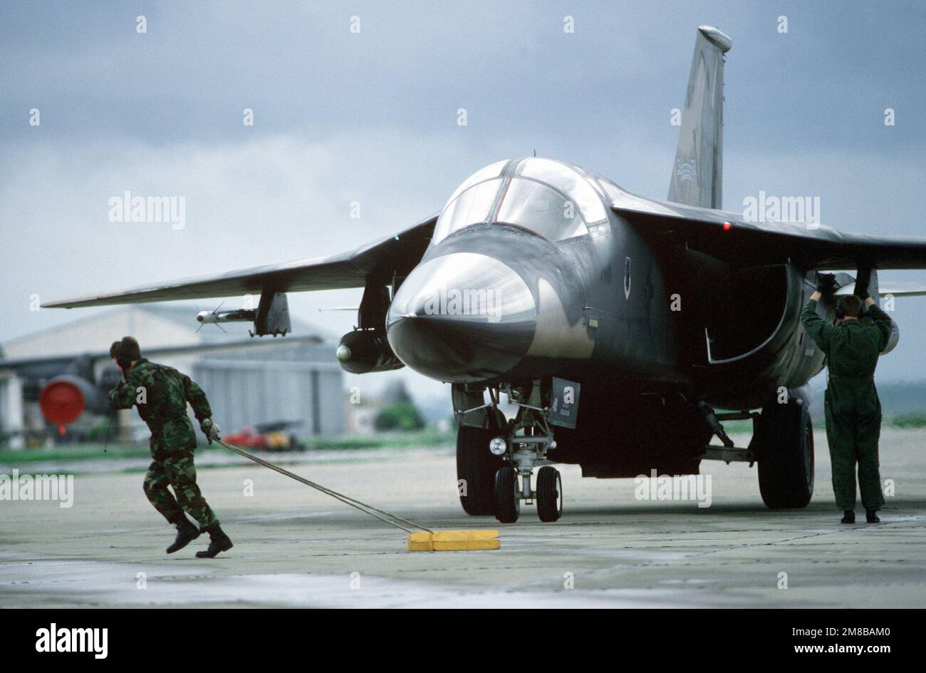 An F-111F aircraft of the 495th Tactical Fighter Squadron is guided out ...