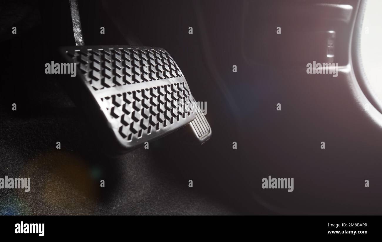 Car accelerate and brake foot pedal. Close up foot press or push foot ...