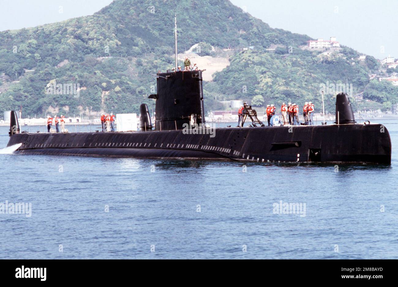 Crew members stand atop the attack submarine USS DARTER (SS 576) as the ...