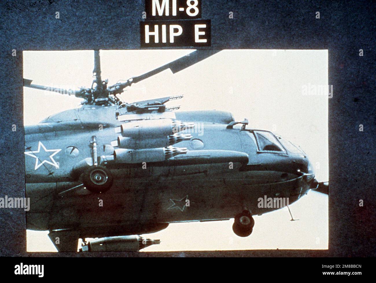 A ground-to-air right side view of a Soviet Mi-8 Hip E helicopter. The ...