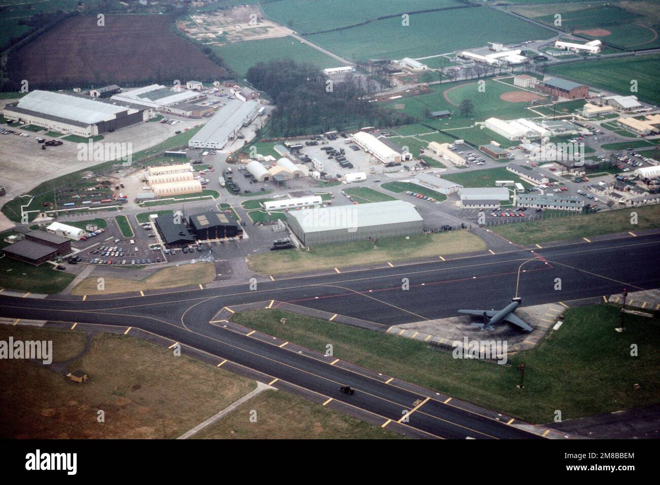 An aerial view of a portion of the base at one end of the main runway ...
