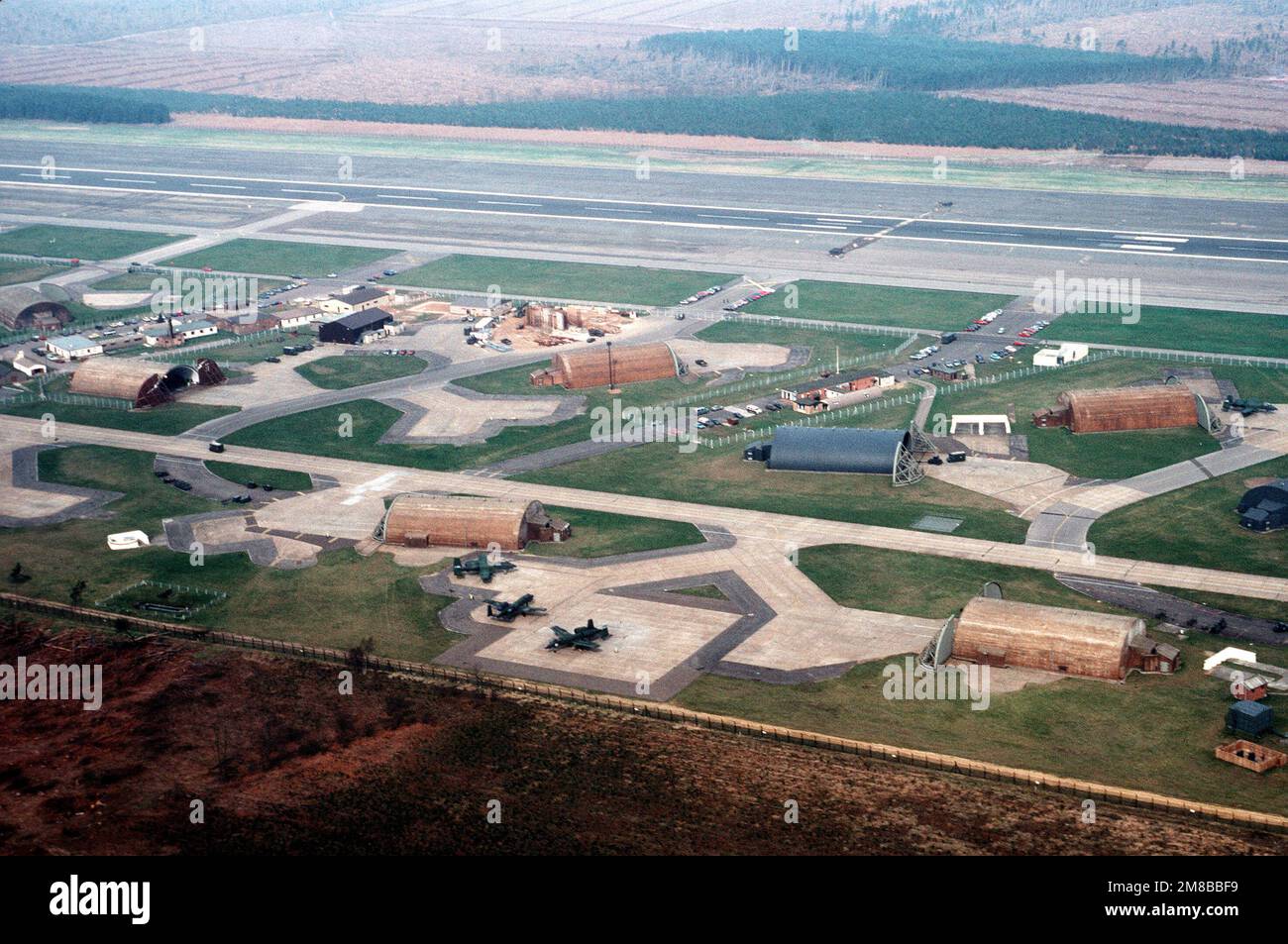 An aerial view of a hangar area and runway on the base, with several A ...