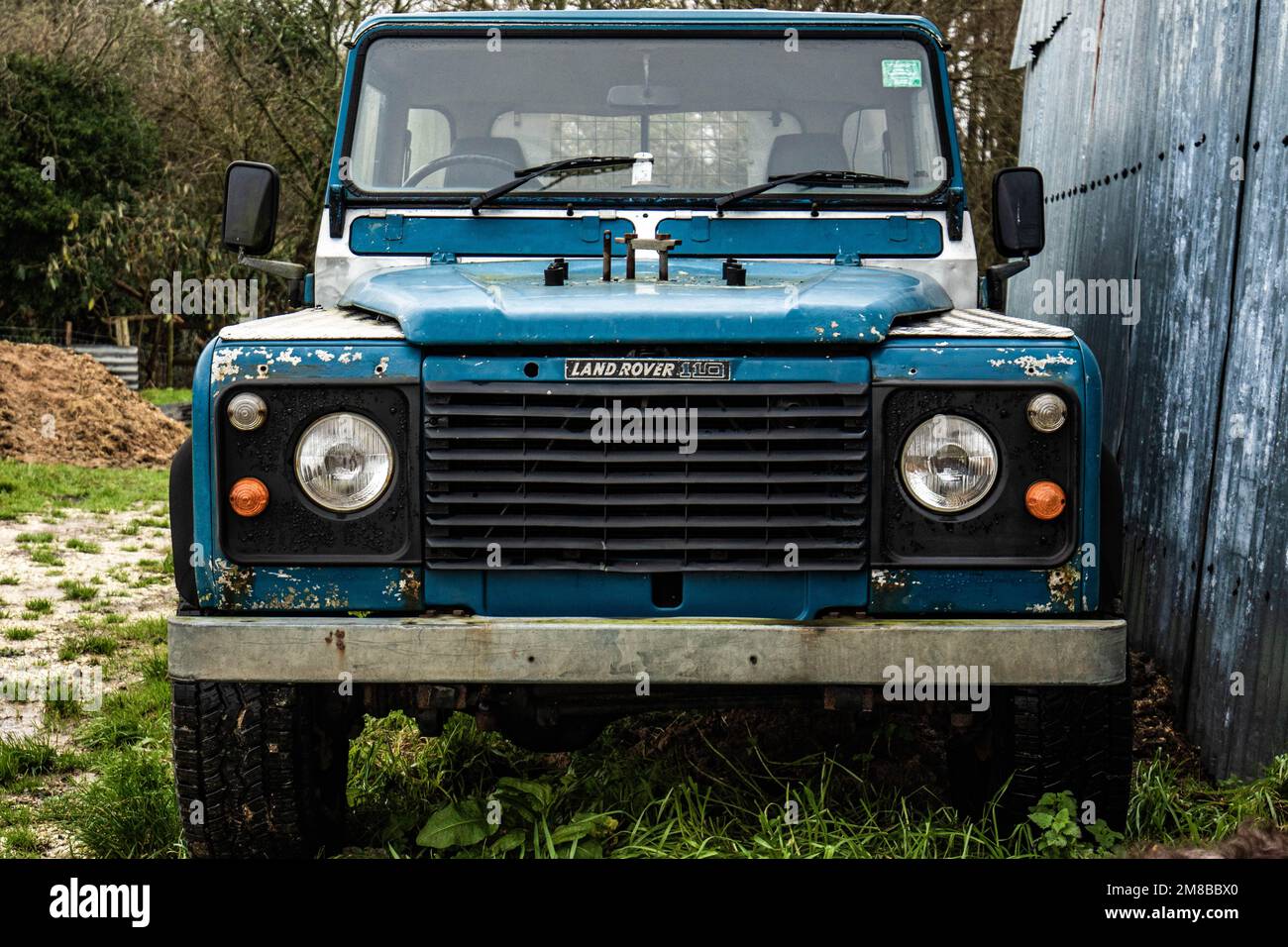 Old classic vintage pick-up Land Rover next to metal shed Stock Photo ...