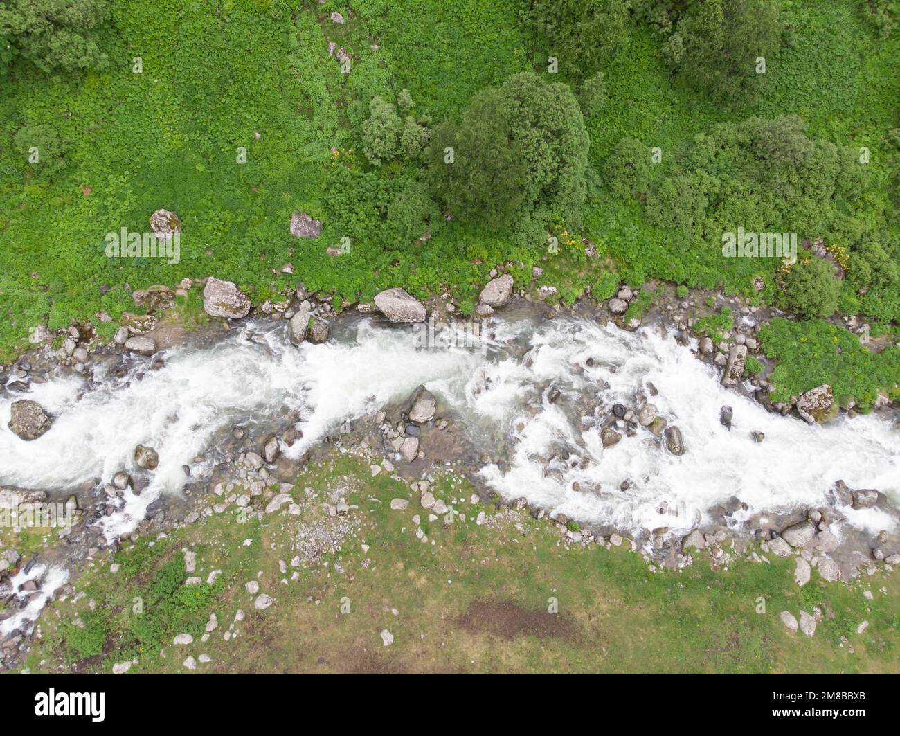 River, top view. Water stream running through stone boulders river in a ...