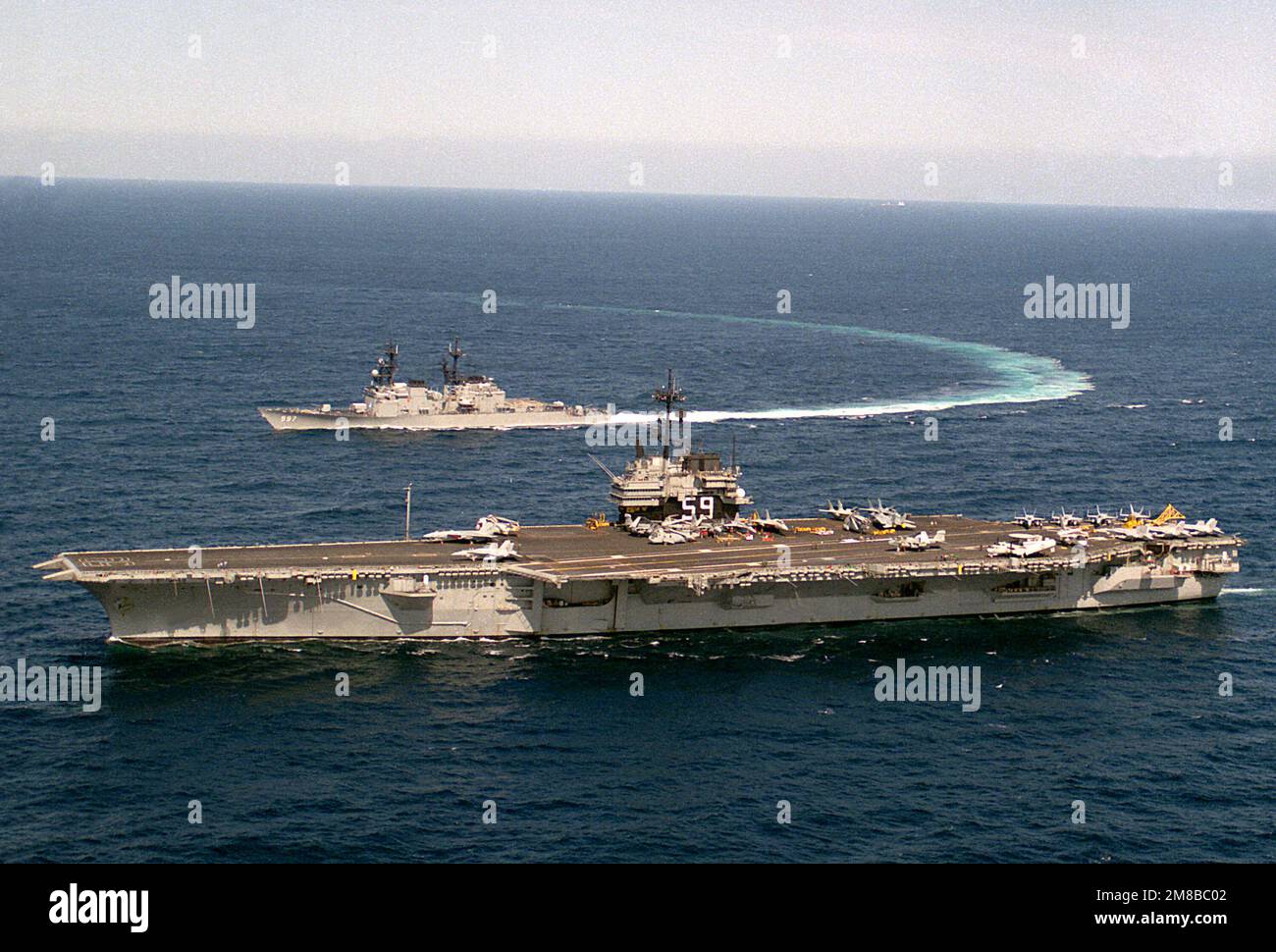 The destroyer USS HAYLER (DD-997) takes its place on the starboard side ...