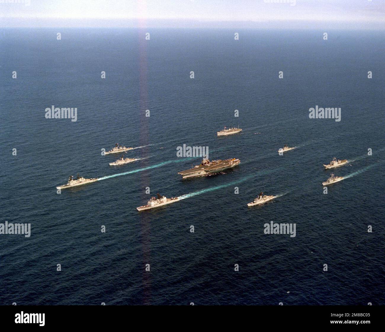 Surrounded by its battle group, the aircraft carrier USS FORRESTAL (CV ...