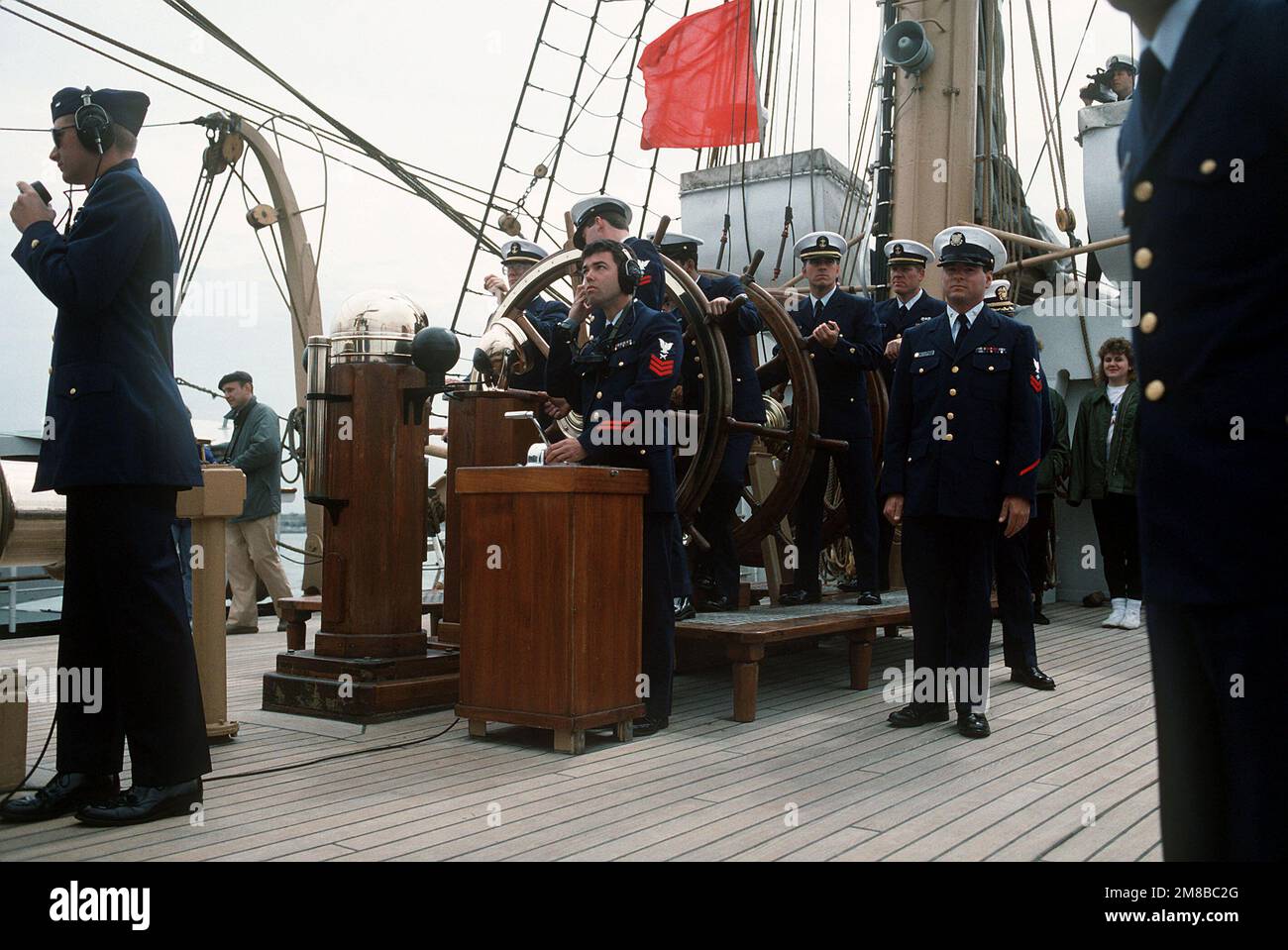 US Coast Guardsmen man the helm of the training bark USCGC EAGLE (WIX ...