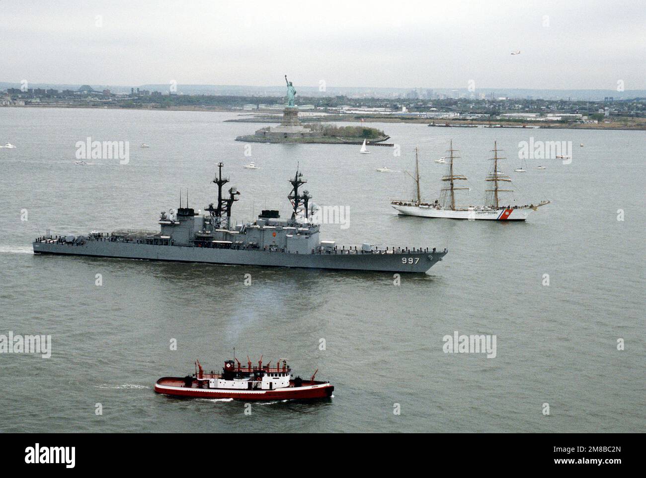 Crew members man the rail aboard the destroyer USS HAYLER (DD 997) as ...