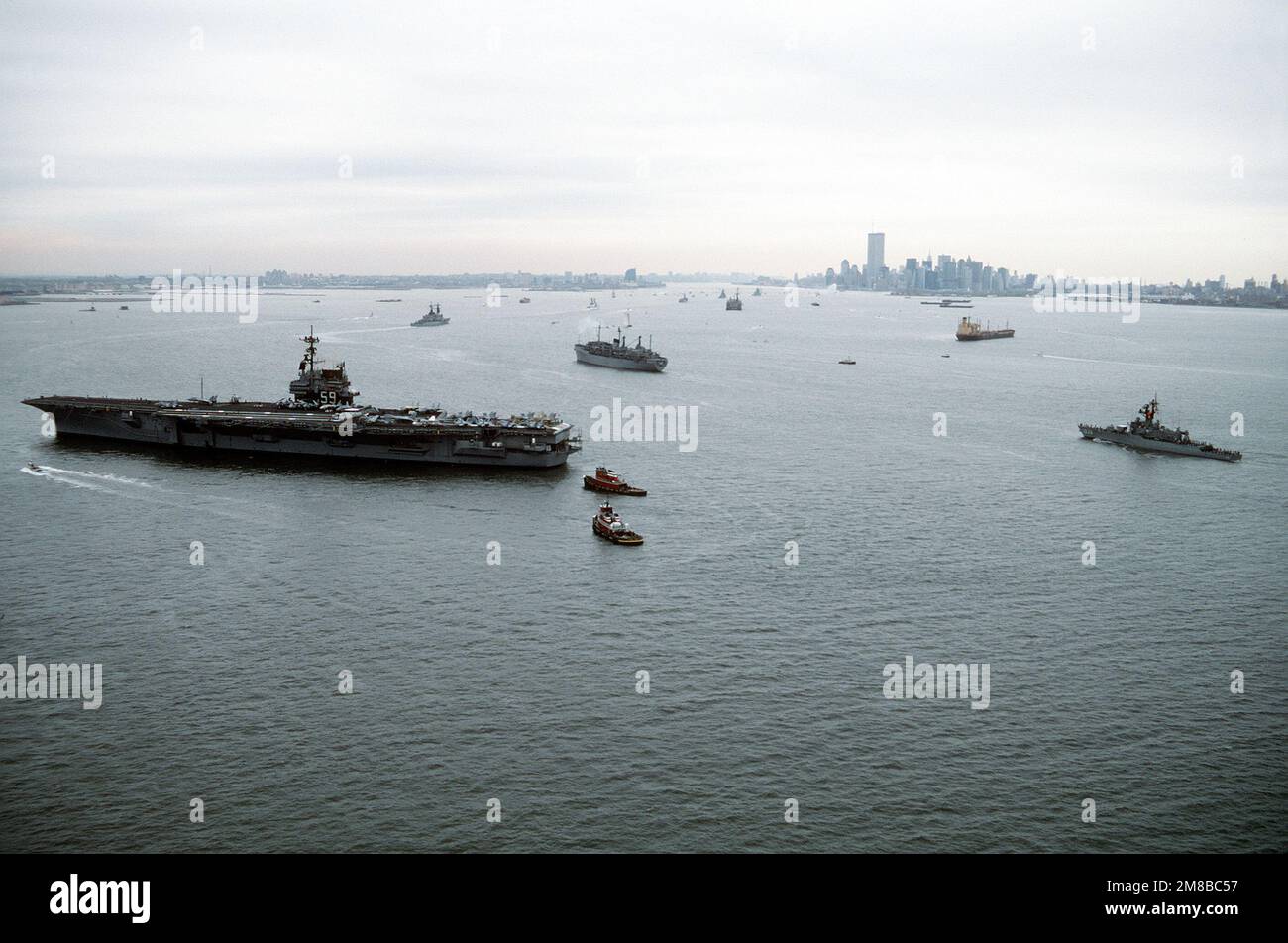 Harbor tugs approach the aircraft carrier USS FORRESTAL (CV-59), lying ...