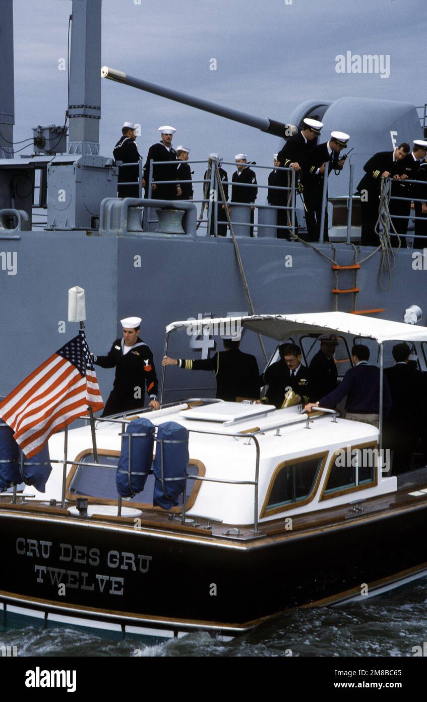 A Cruiser Destroyer Group 12 motor launch pulls away from the guided ...