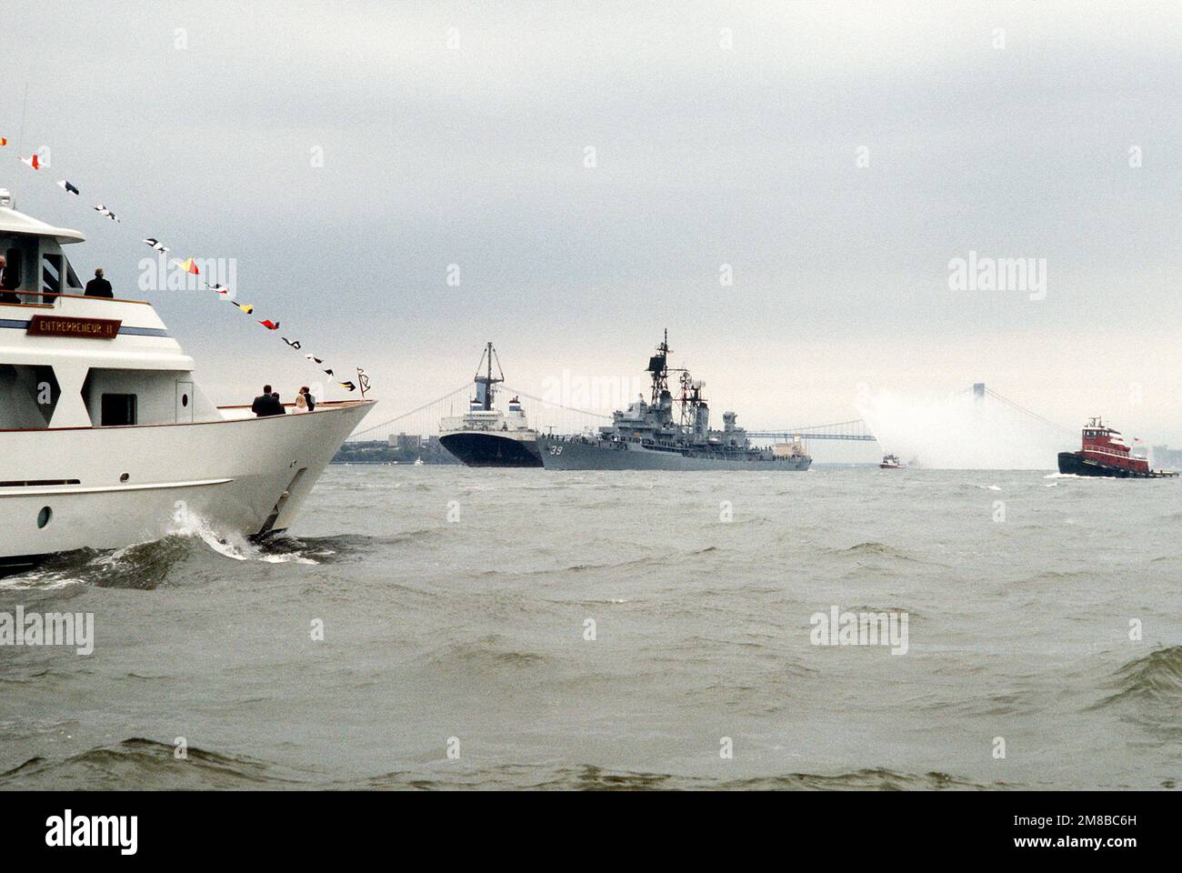 The guided missile destroyer USS MACDONOUGH (DDG-39) steams between a ...