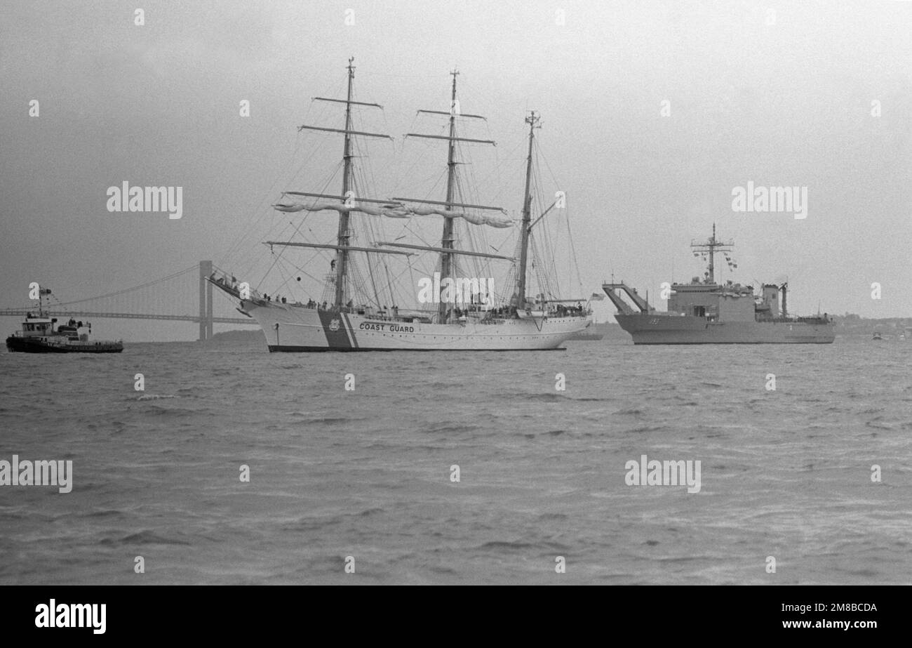 The tank landing ship USS FAIRFAX COUNTY (LST 1193), right, approaches ...