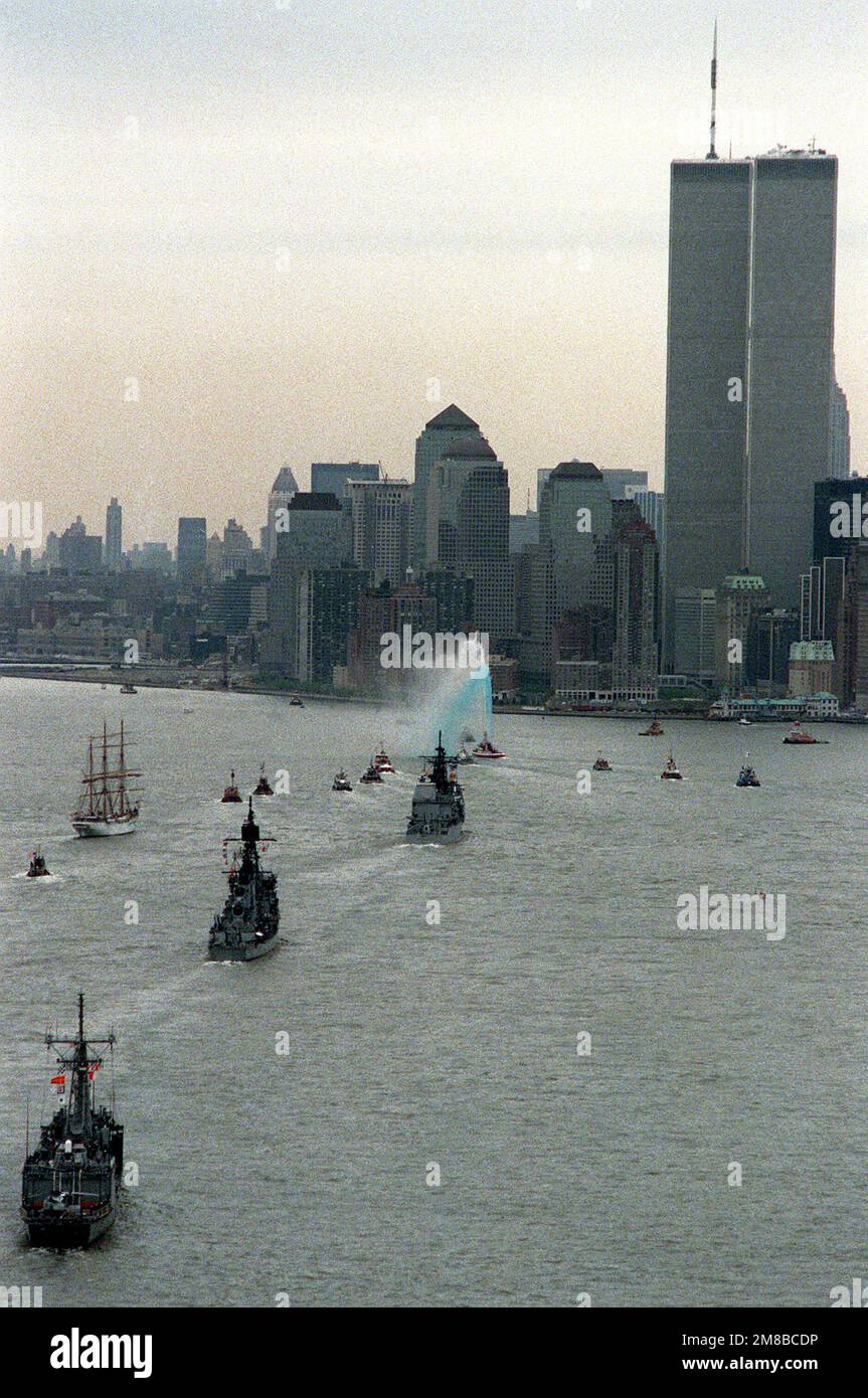 A parade of US Navy and Coast Guard ships move toward Manhattan as they ...