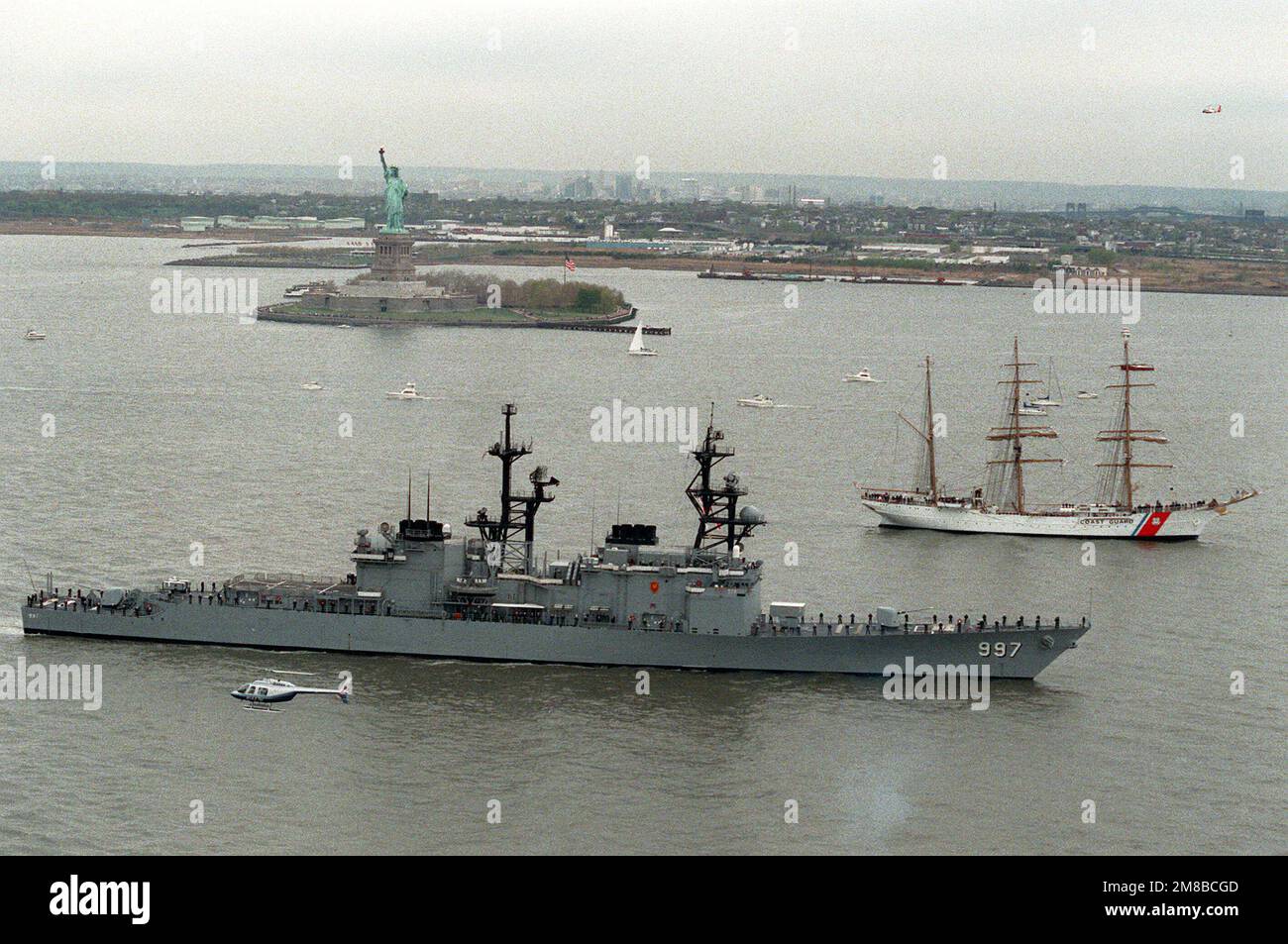 Crew members man the rail aboard the destroyer USS HAYLER (DD 997) as ...