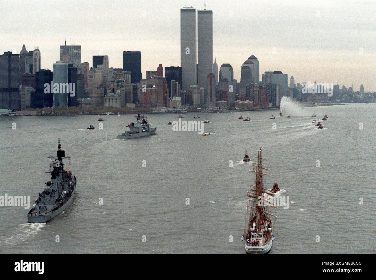 A parade of US Navy and Coast Guard ships approaches Manhattan as they ...