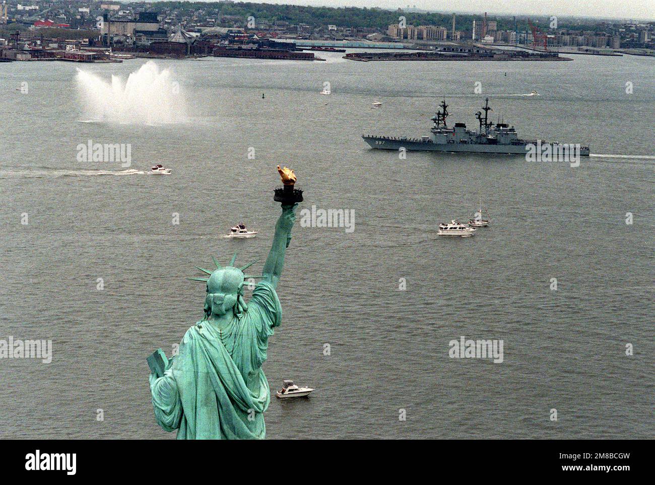 Crew members man the rail aboard the destroyer USS HAYLER (DD 997) as ...