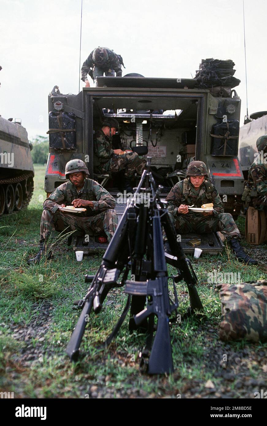 Behind a tepee of M16A1 rifles, newly arrived soldiers of the 1ST ...
