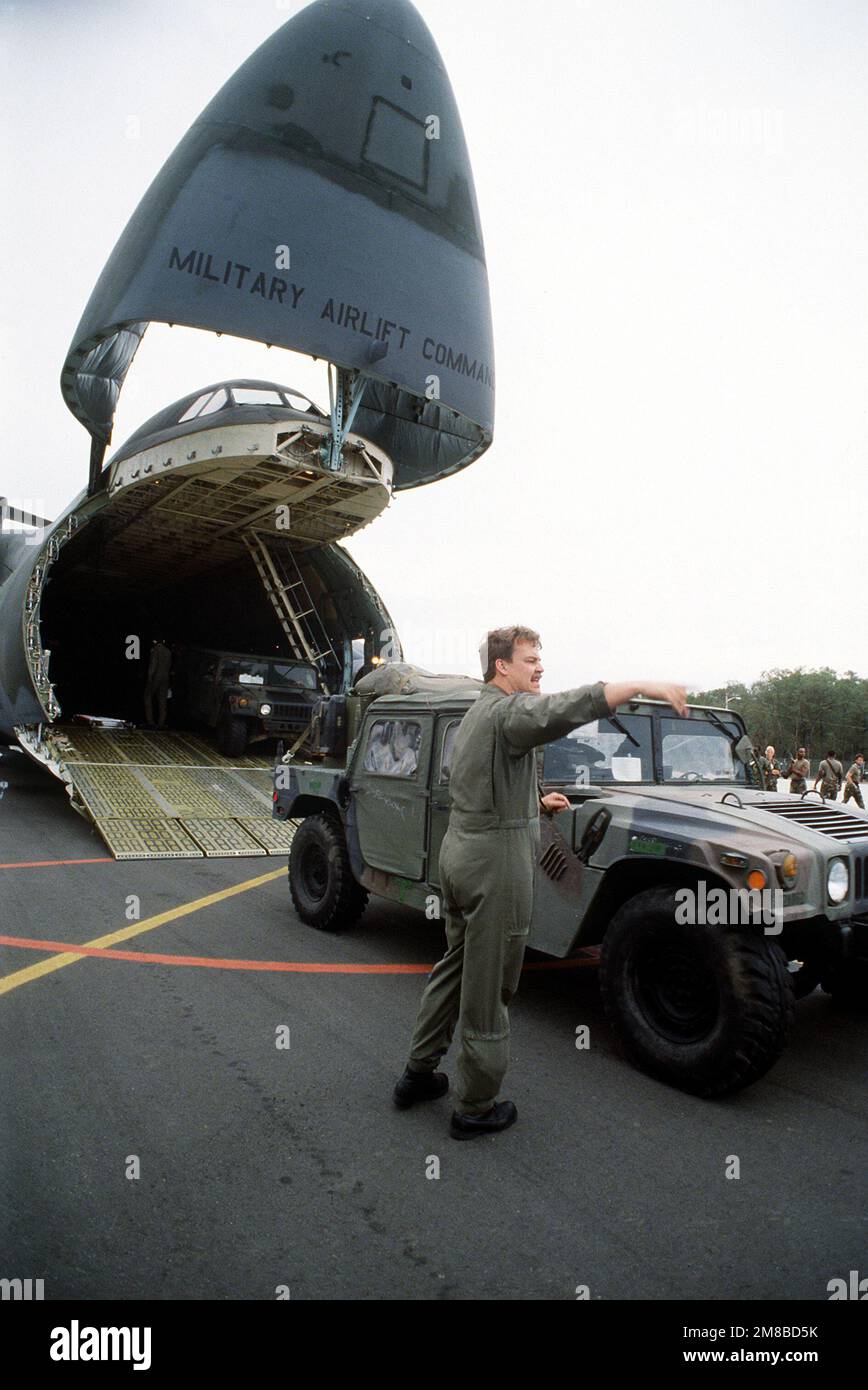 A C-5 Galaxy aircraft unloads M998 High-Mobility Multipurpose Wheeled ...