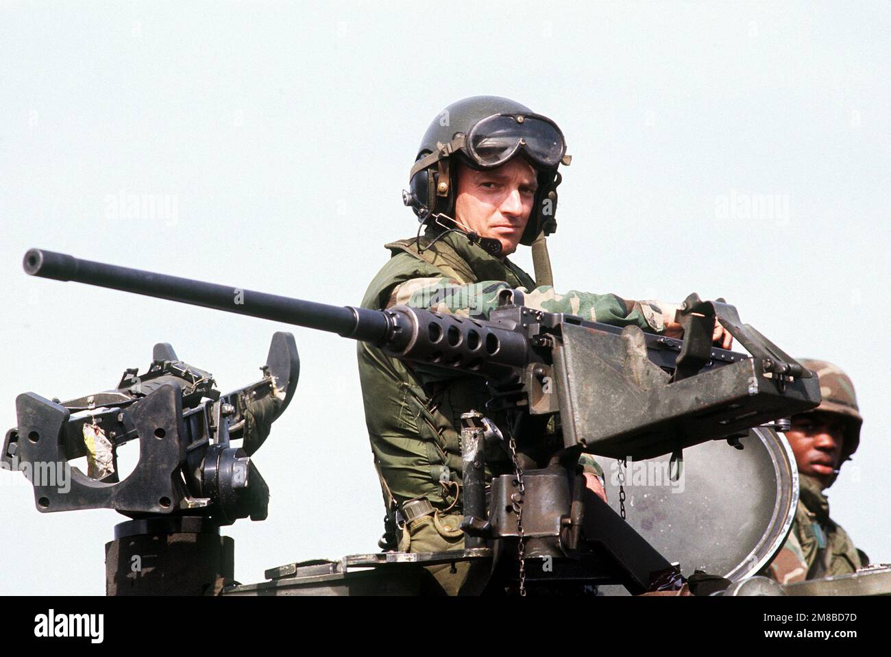 A soldier mans an M-2 .50-caliber machine gun on an armored personnel ...