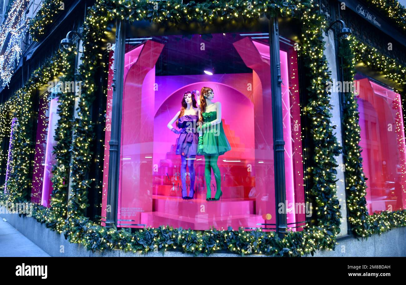 Spectators view holiday window display at Saks Fifth Avenue in NYC ...