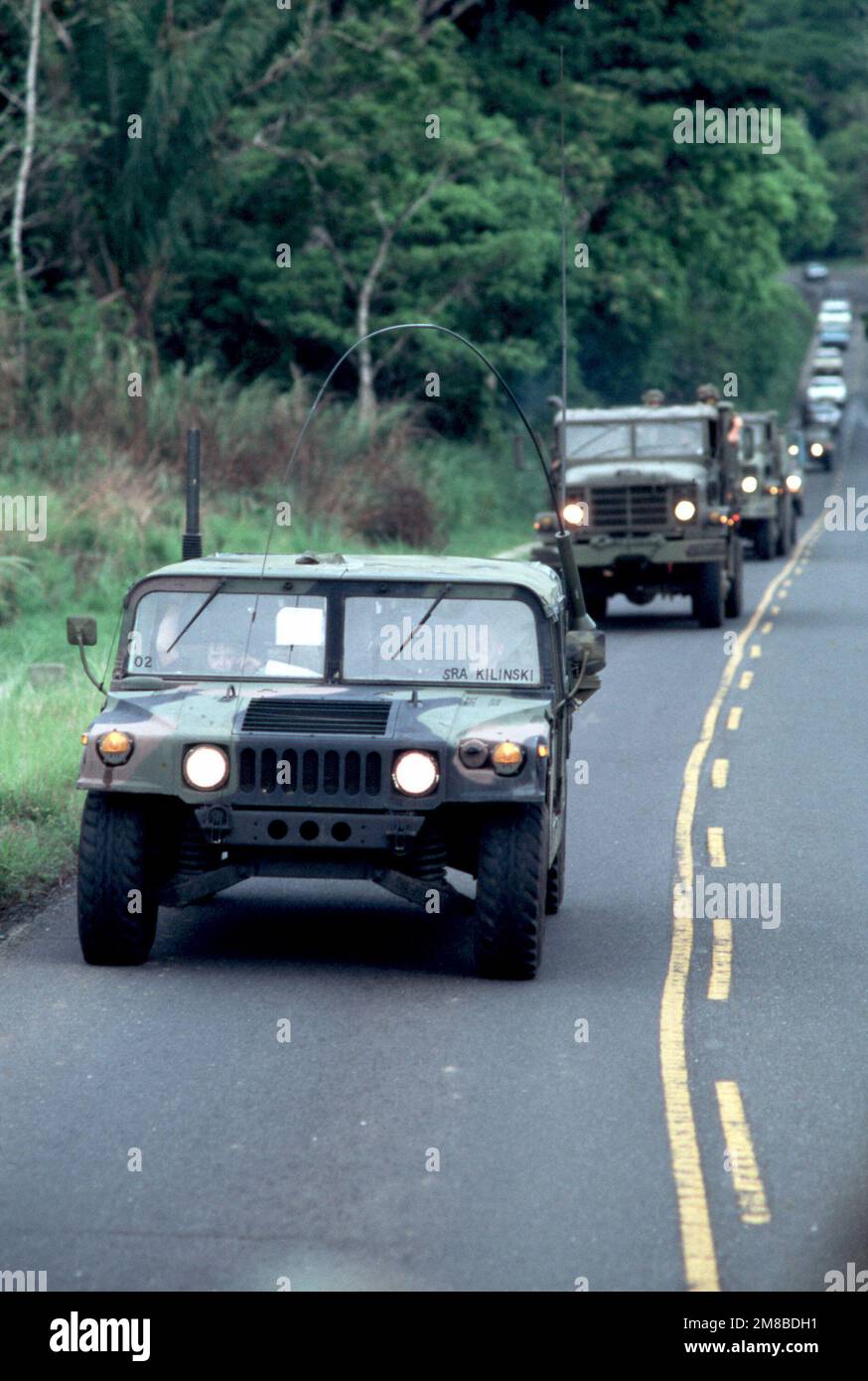 An M998 High Mobility Multi-purpose Wheeled Vehicle (HMMWV) leads a ...
