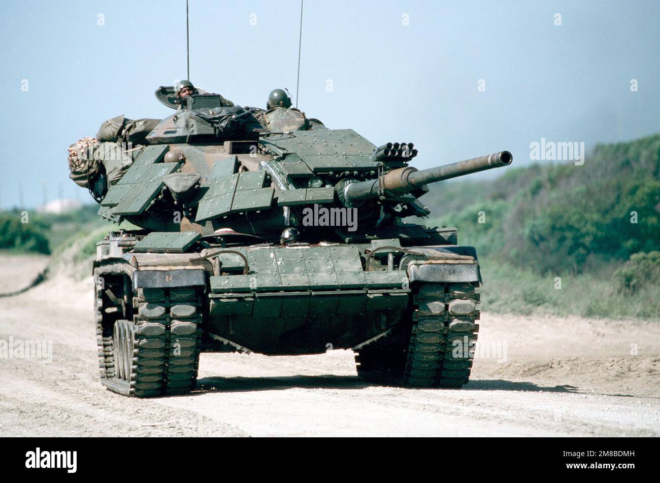 A Marine Corps M60 main battle tank with reactive armor bolted to its ...