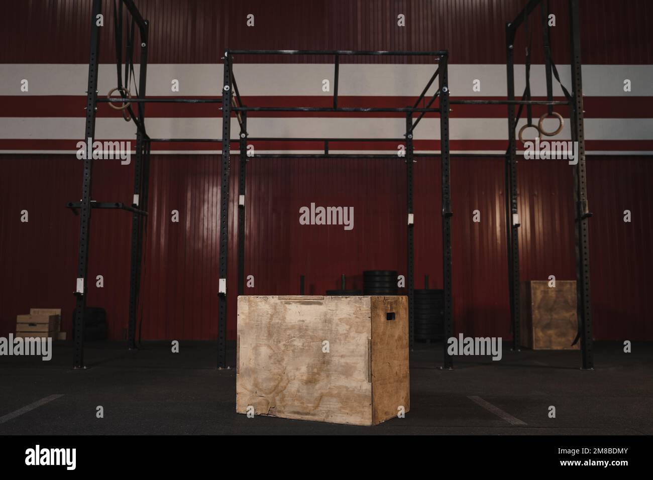 Crossfit gym with workout equipment. Box jumps horizontal bars ...