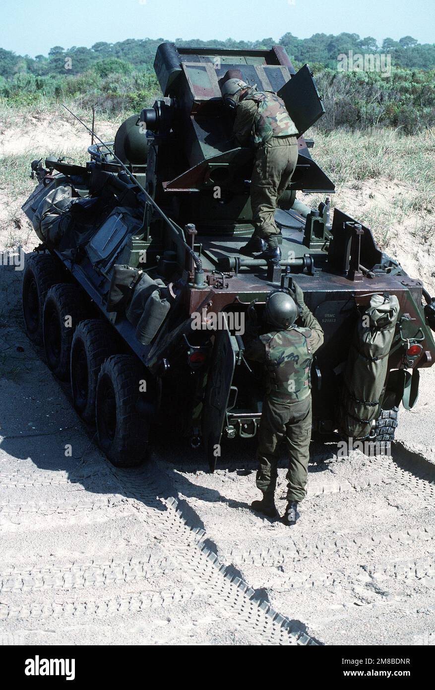 A crewman services the tube-launched, optically tracked, wire-guided ...