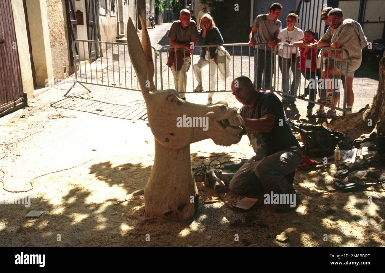 Woodcarver at the traditional festival of the donkey in La ...
