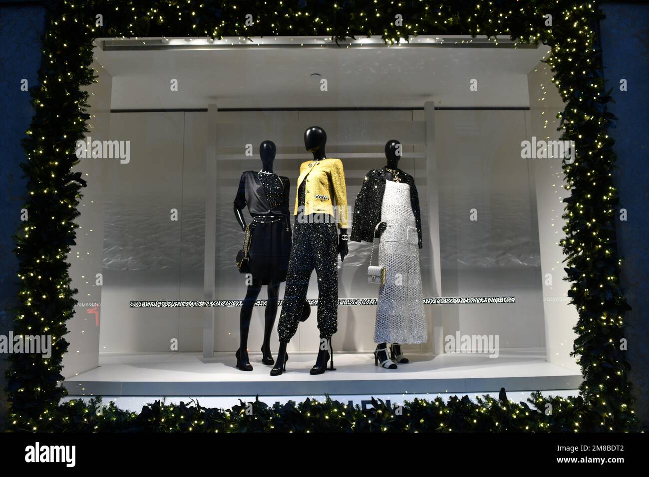 Spectators view holiday window display at Saks Fifth Avenue in NYC ...