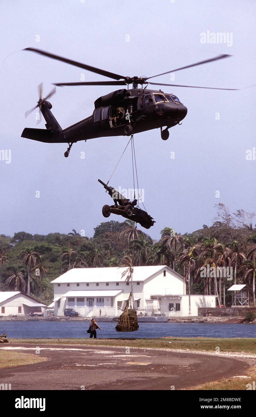 A UH-60 Black Hawk (Blackhawk) helicopter carries an M-102 105mm ...