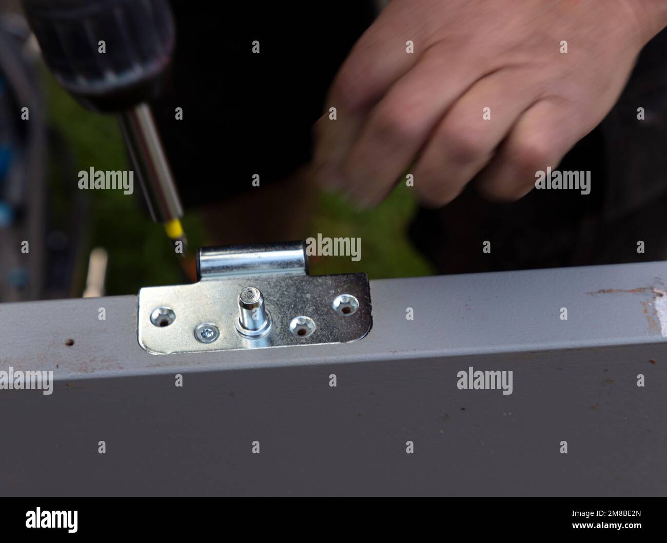 A closeup of a handyman making a door fitting with an automatic ...