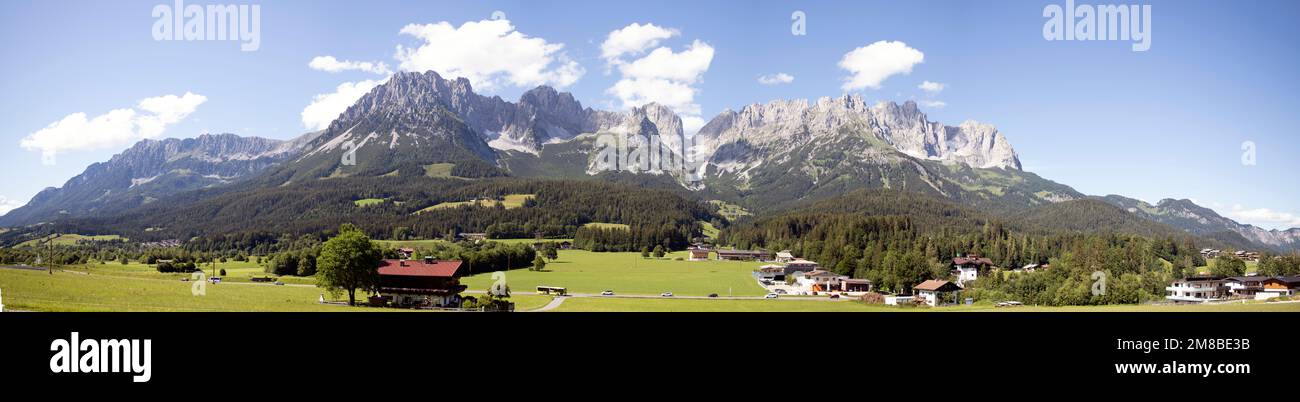 A panoramic view of mesmerizing rocky mountains with beautiful fields ...
