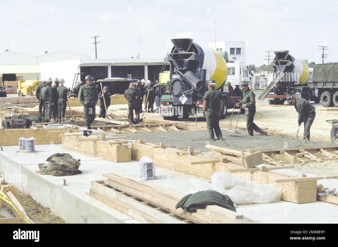 Seabees put down cement for new sections of the flight line. Base ...