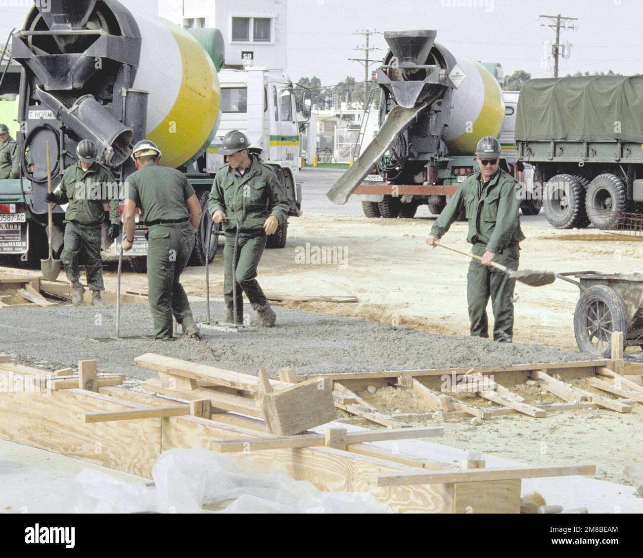 Seabees smooth down cement for new sections of the flight line. Base ...