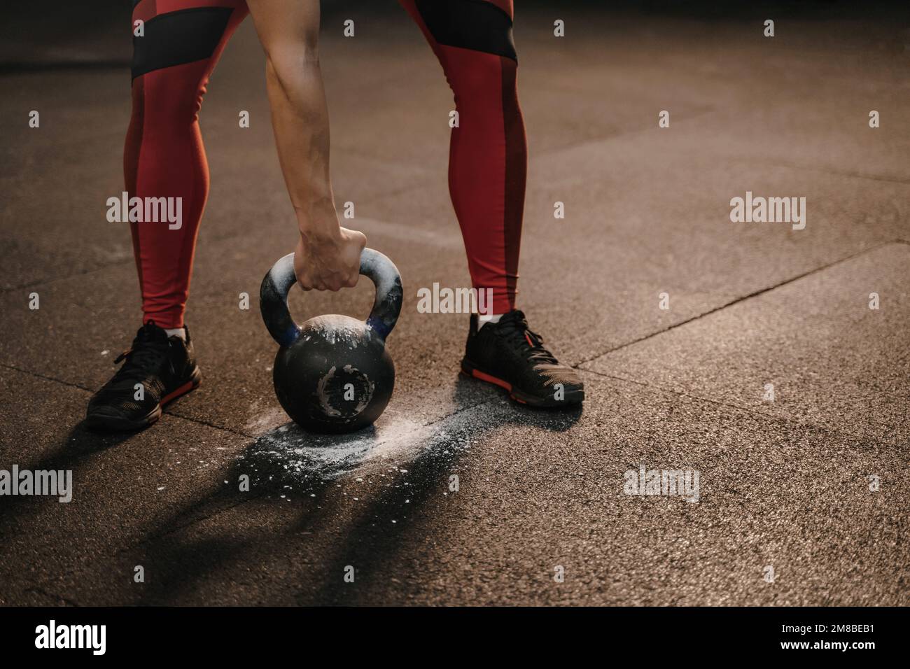 Closeup of sports woman holding kettlebell while crossfit training ...