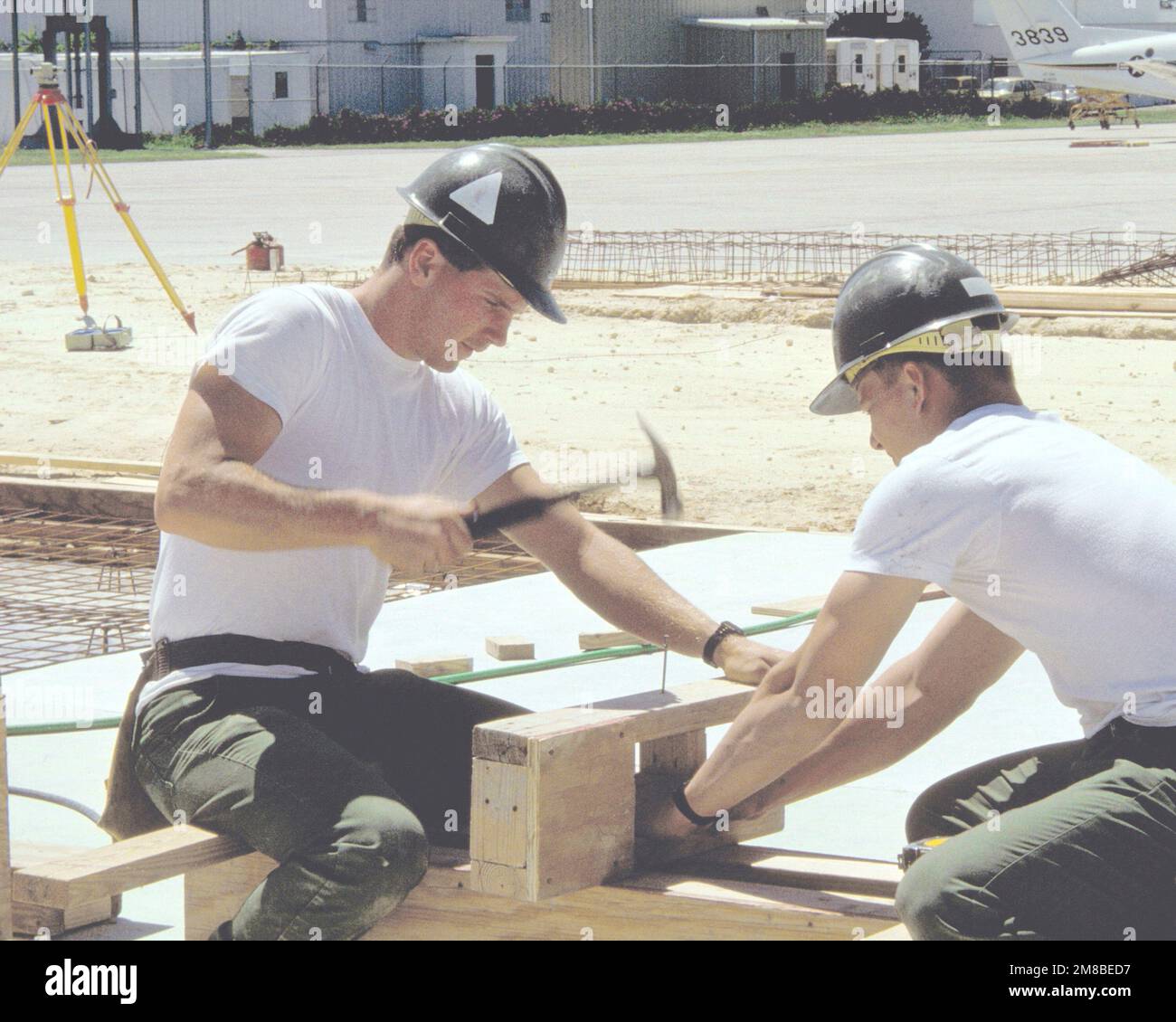 Seabees hammer together a crossbeam for a new building. Base: Naval ...