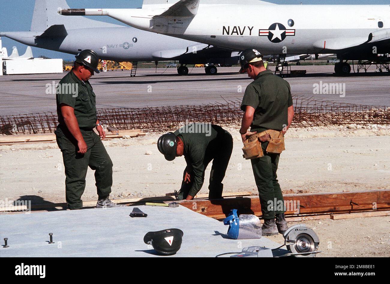 Seabees prepare the foundation of a new building outside a hangar of ...