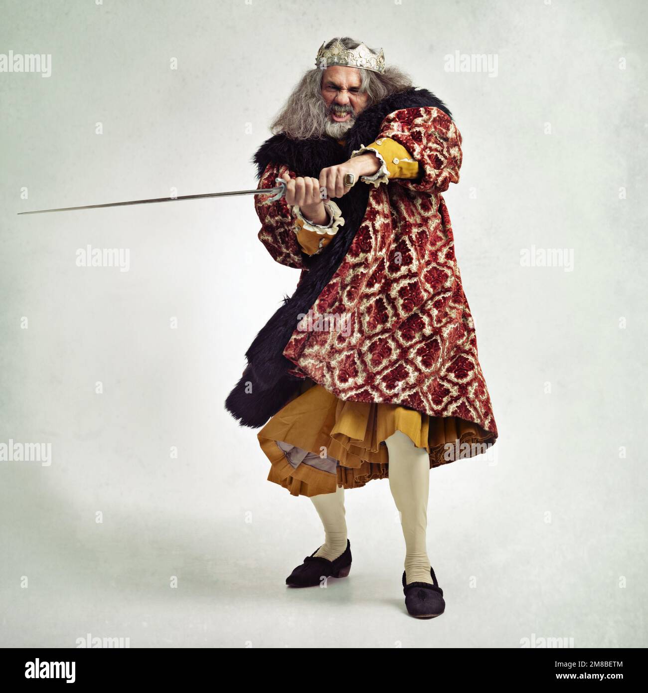 Man, royalty and portrait of king with sword in studio isolated on a ...