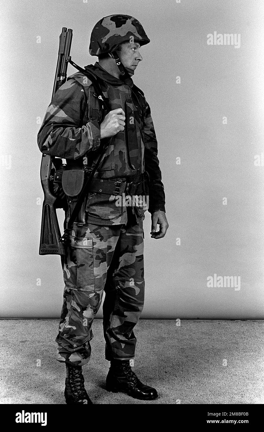 A Marine demonstrates sling arms with an M-870, Mark 1 12-gauge shotgun ...