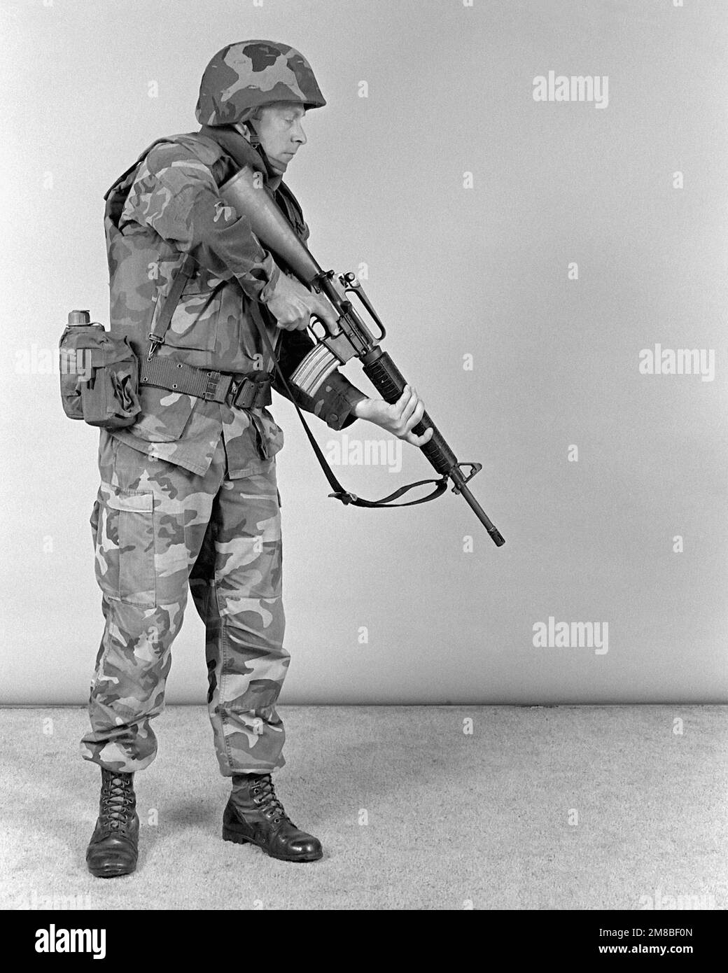 A Marine demonstrates a ready position with an M-16A2 5.56mm rifle ...