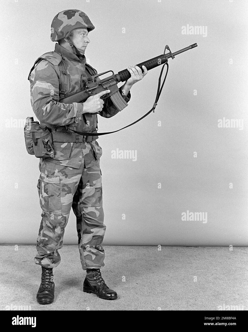A Marine demonstrates a ready position with an M-16A2 5.56mm rifle ...