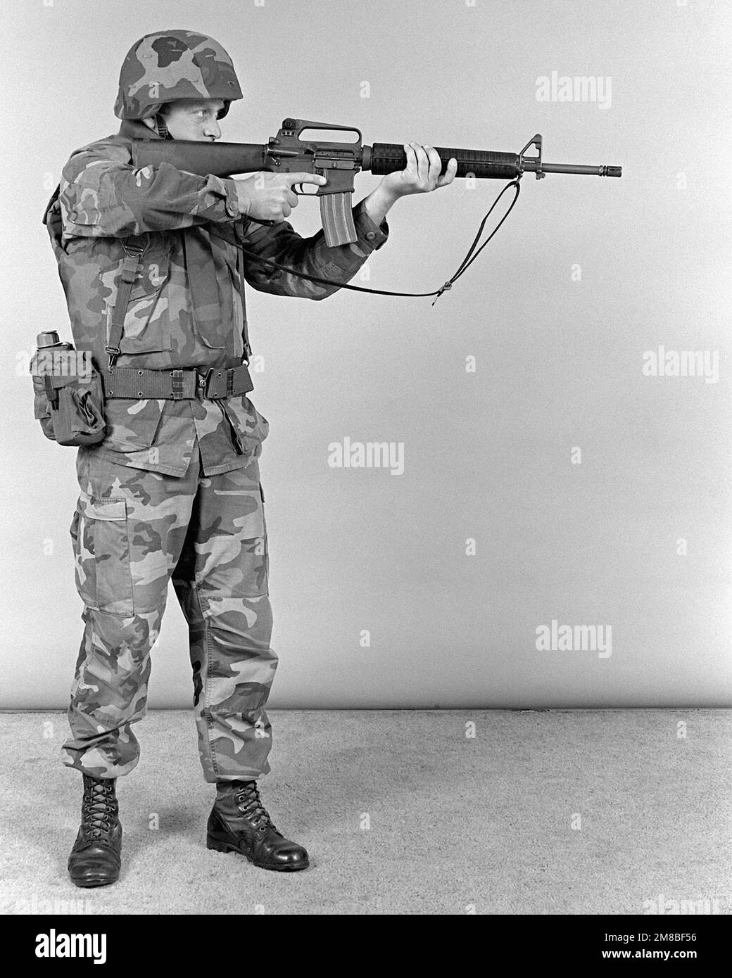 A Marine demonstrates a standing firing position with an M-16A2 5.56mm ...