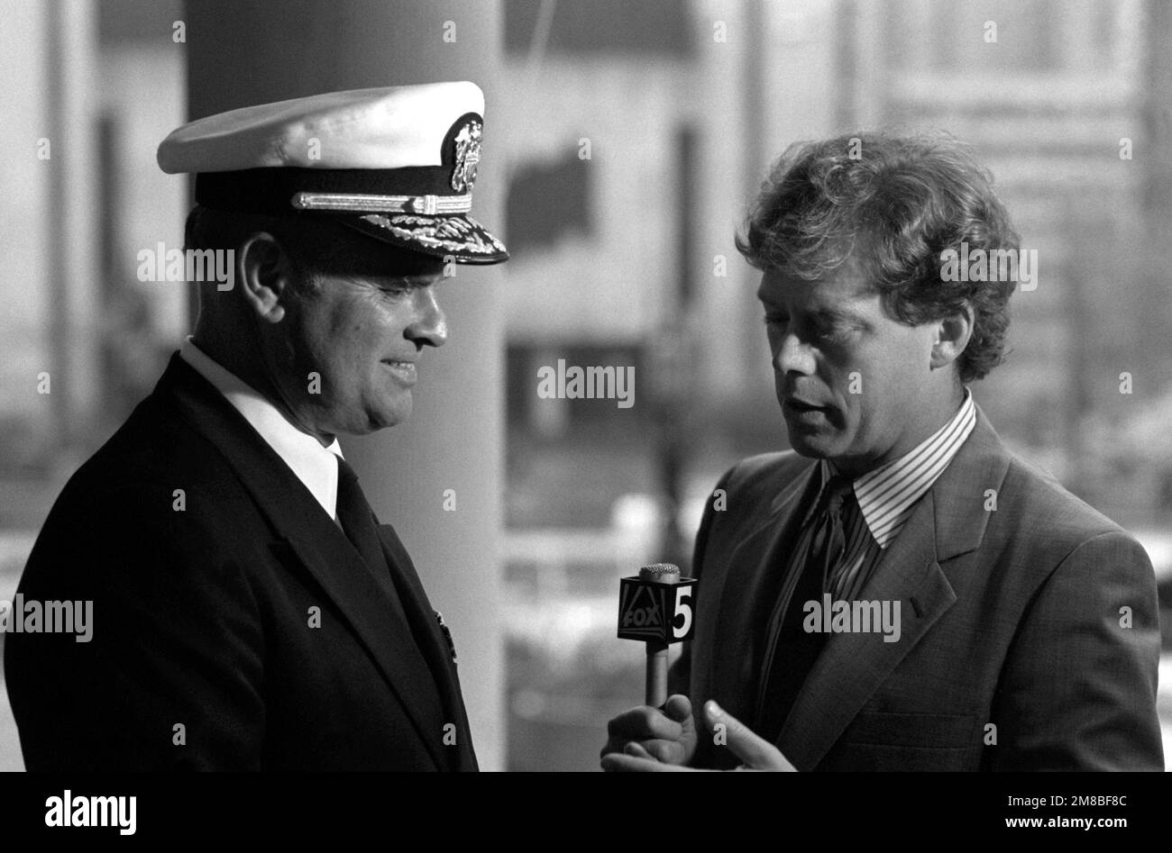A television reporter interviews Vice Admiral Roger F. Bacon, Commander ...