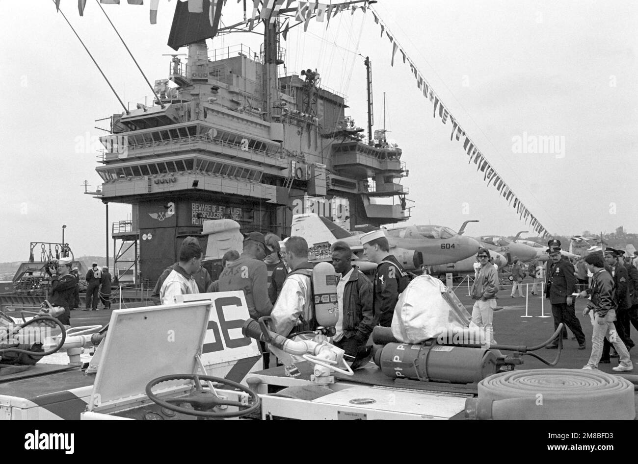 Visitors view the displays on the flight deck of the aircraft carrier ...