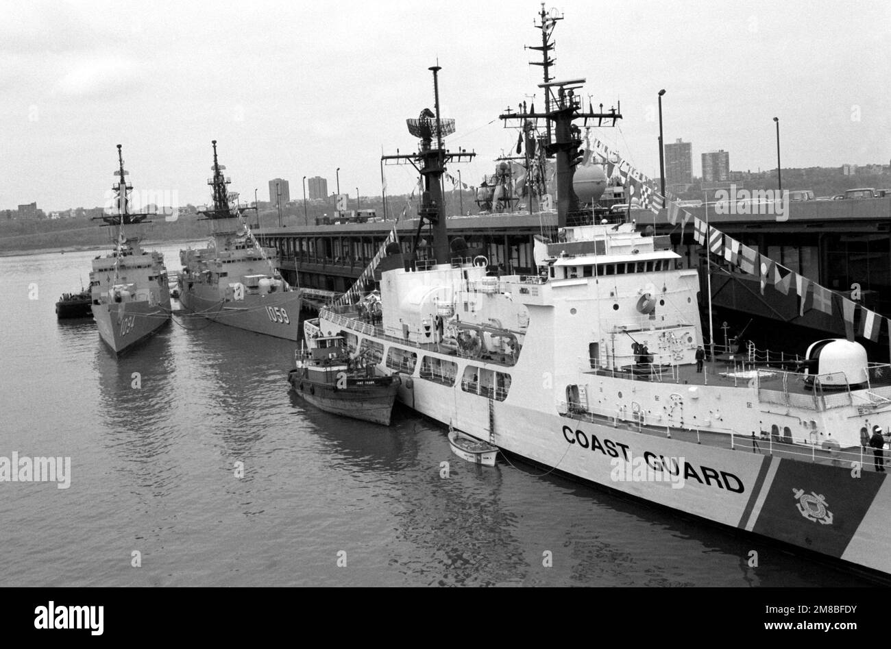 US Navy and Coast Guard ships lie tied up at the Manhattan Passenger ...