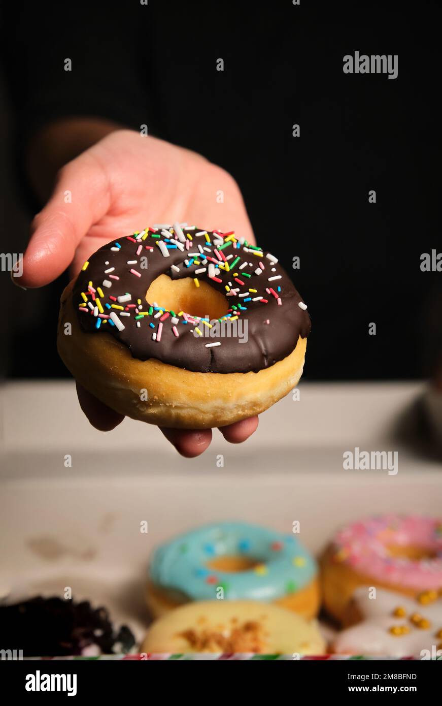 donut with chocolate in a woman's hand Stock Photo - Alamy