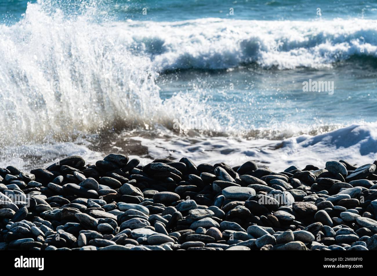 sea spray on the beach on the stone coast Stock Photo - Alamy