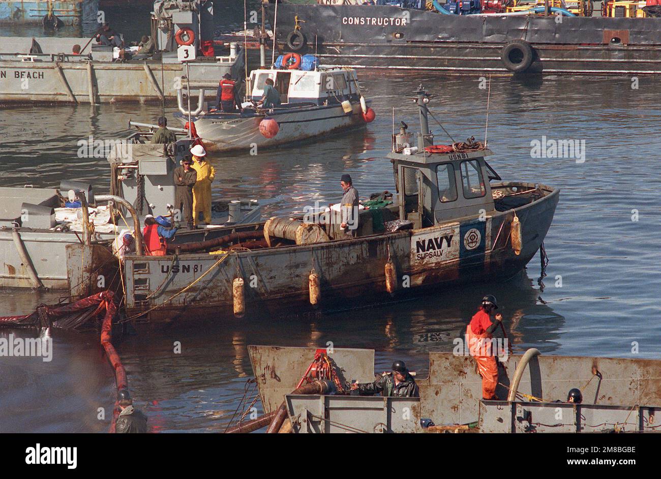 Crewmen position equipment on a U.S. Navy diving support vessel during ...